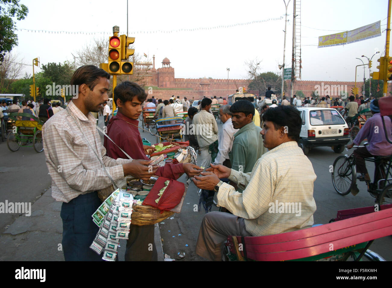 Delhi,India March 27 2004 : A cycle rickshaw passenger takes beetle ...