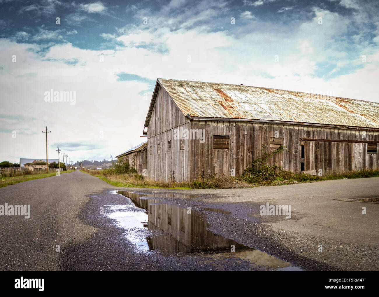 A reflection of an old barn in a puddle of rainwater Stock Photo - Alamy