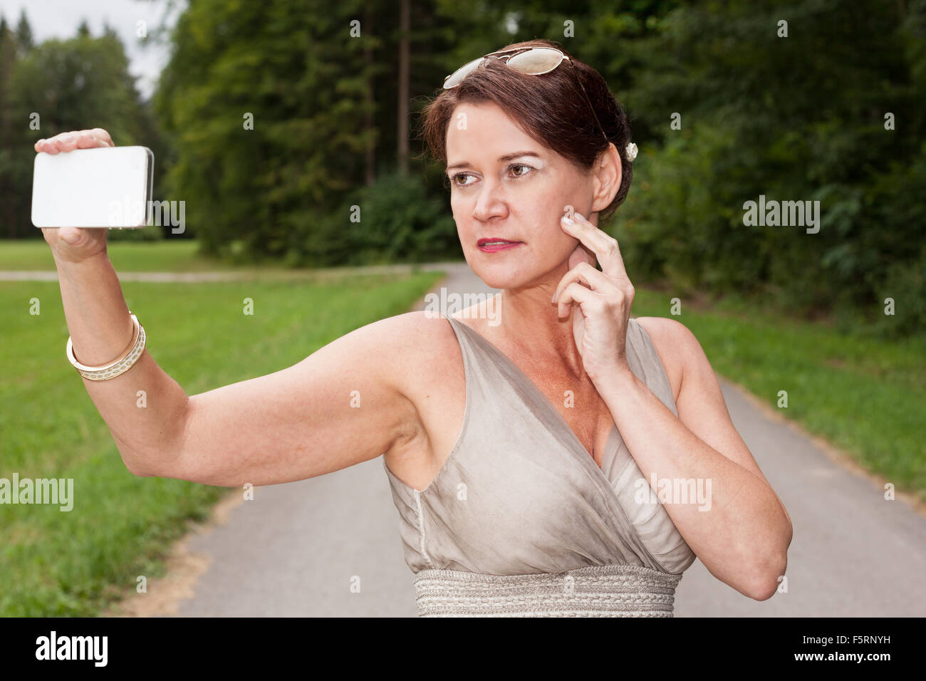 Woman in Gown Taking Self Portrait with Cell Phone Stock Photo - Alamy