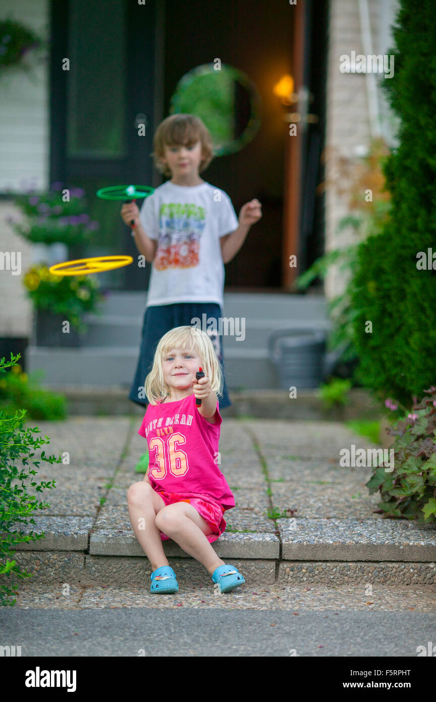 Kids playing in front of house hi-res stock photography and images - Alamy