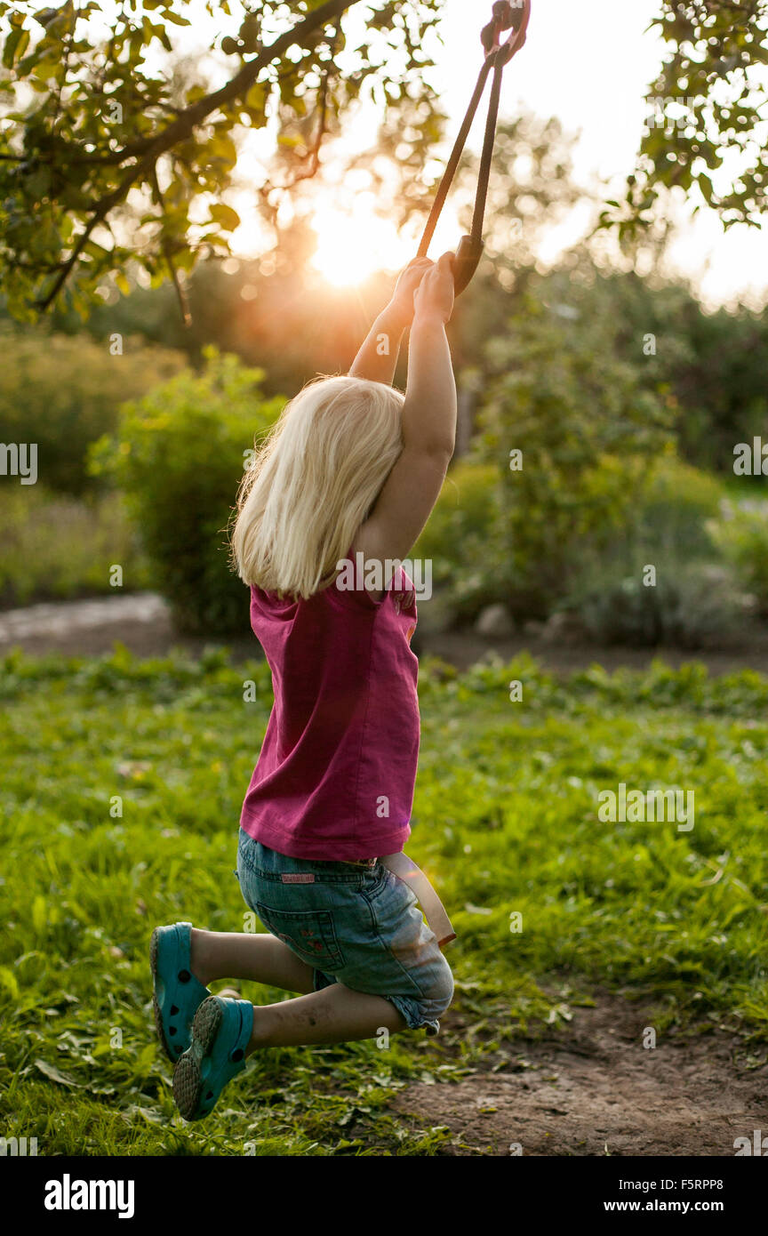 Child swinging from tree hi-res stock photography and images - Alamy
