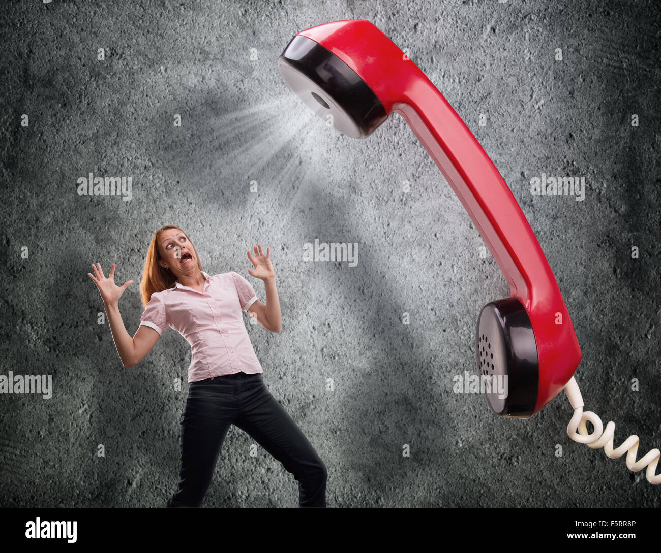 Big phone is screaming to scared woman Stock Photo - Alamy