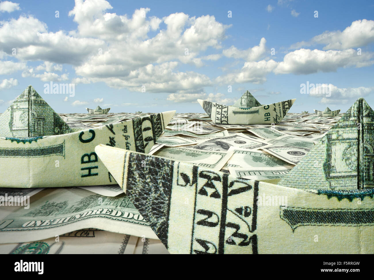 Fleet of dollar boats swimming in financial sea Stock Photo - Alamy