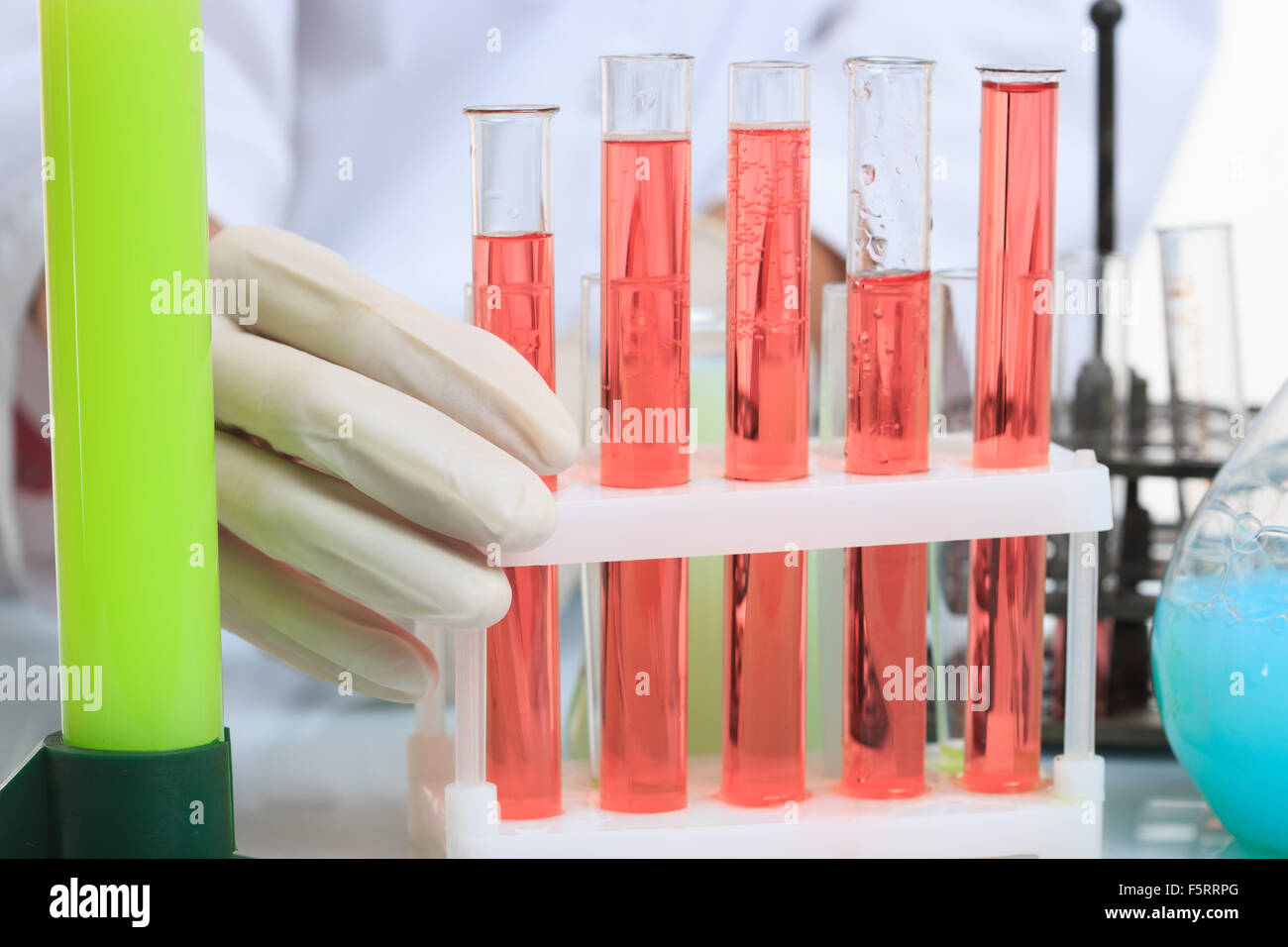 hands holding test tubes with chemical elements Stock Photo - Alamy