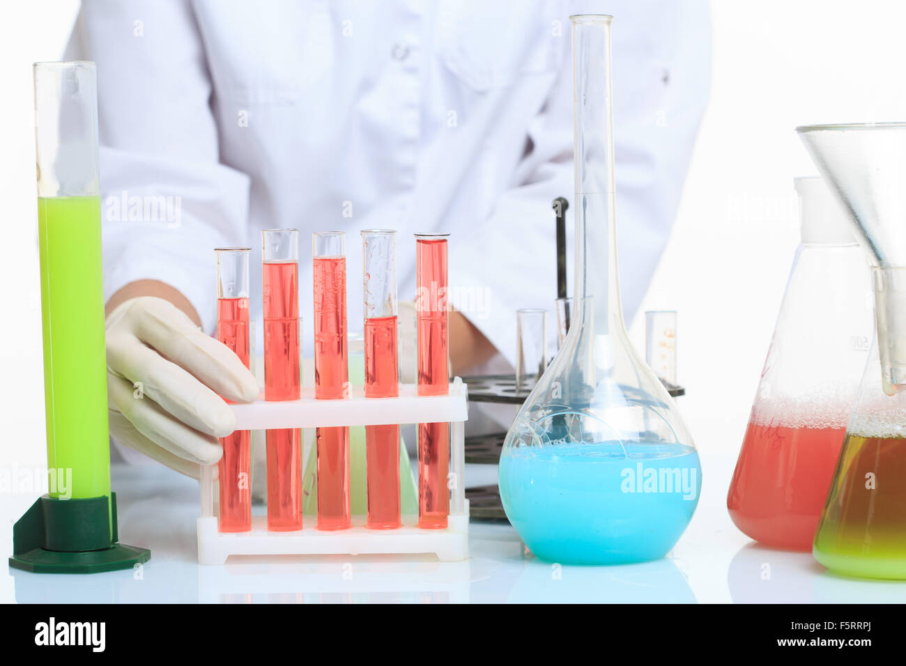 hands holding test tubes with chemical elements Stock Photo - Alamy