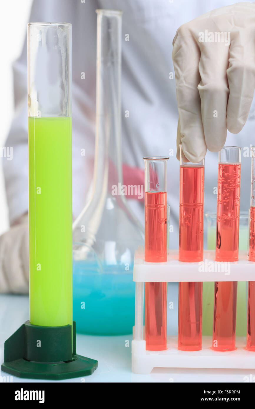 hands holding test tubes with chemical elements Stock Photo - Alamy
