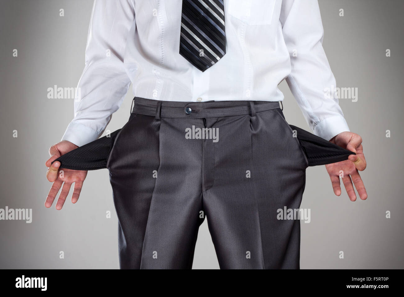Businessman pulling empty out pants hi-res stock photography and images ...