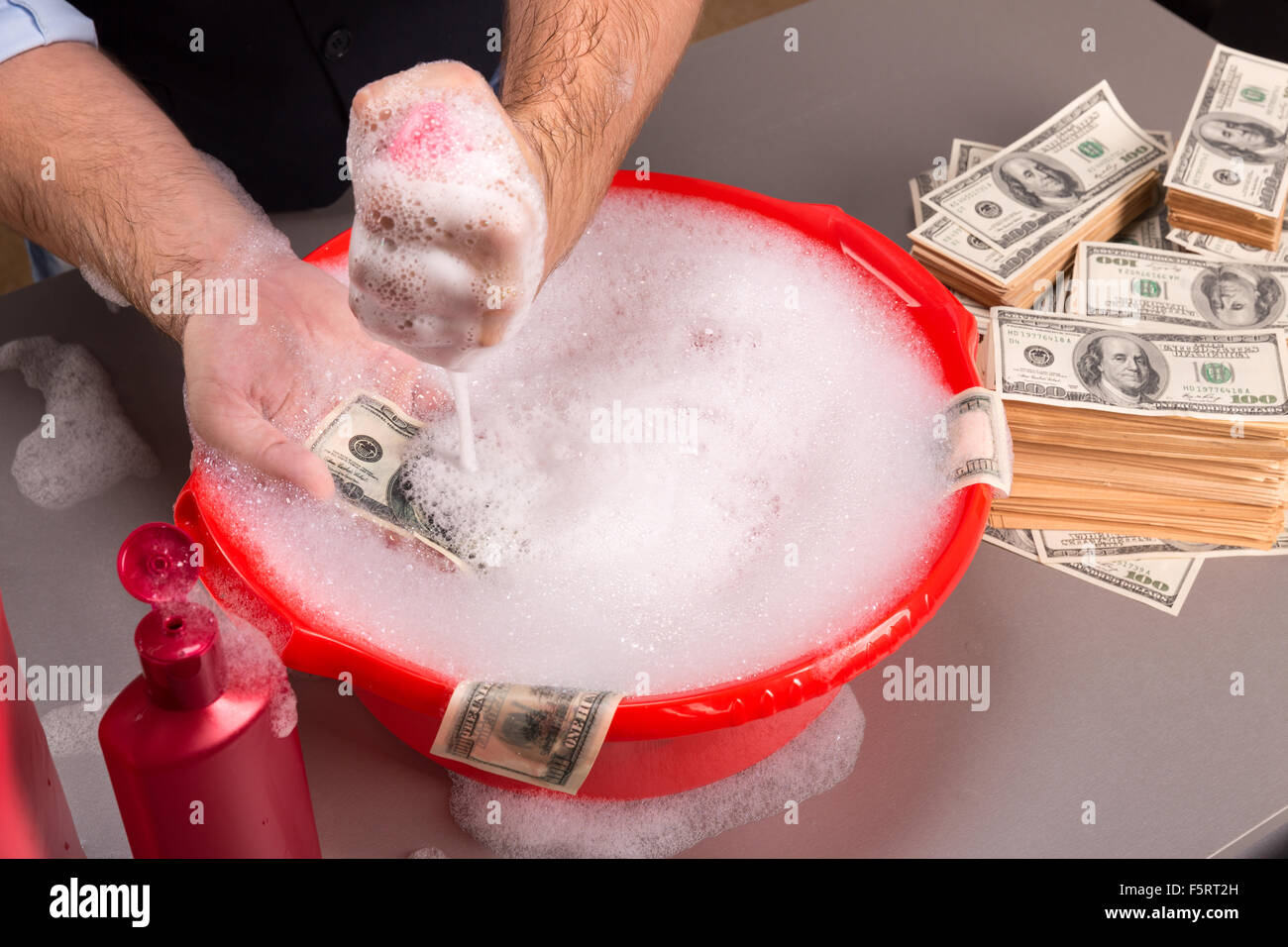Hands are washing dollars banknotes in foam in red washbowl Stock Photo ...