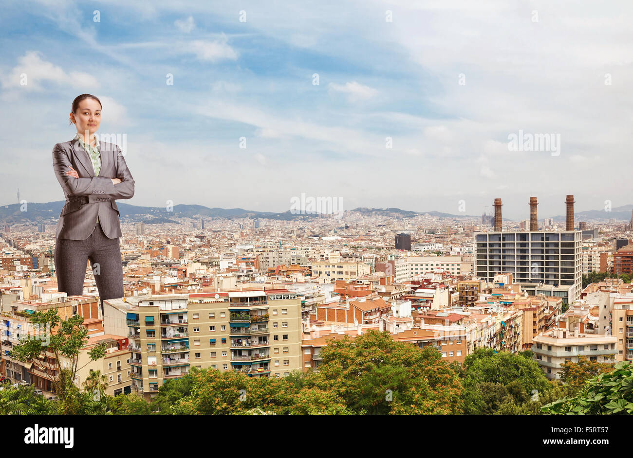 Giant businesswoman among the city buildings Stock Photo - Alamy Giant businesswoman among the city buildings Stock Photo - Alamy