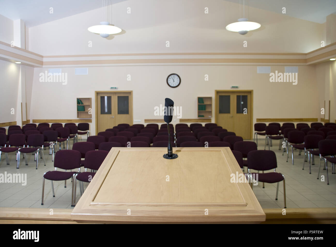 Empty conference auditorium. Microphone and seats Stock Photo - Alamy