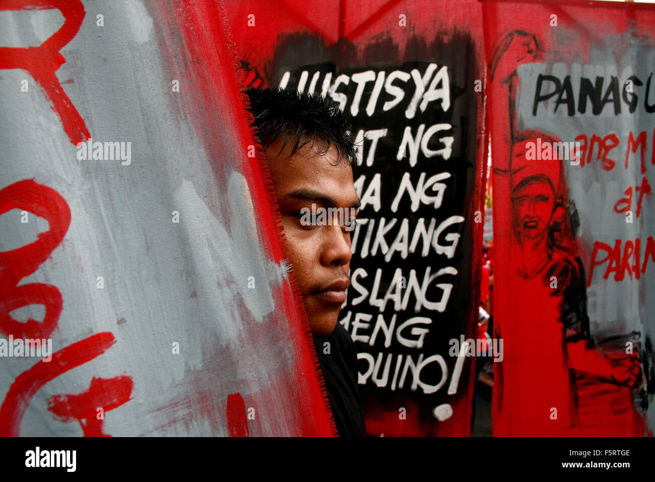 Philippines. 9th Nov, 2015. A Lumad tribe member stands along banners ...