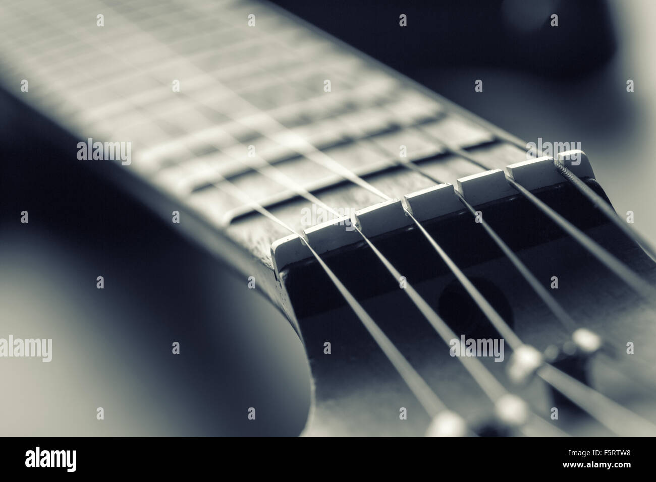 Closeup of electric guitar fretboard with strings. Toned Stock Photo ...