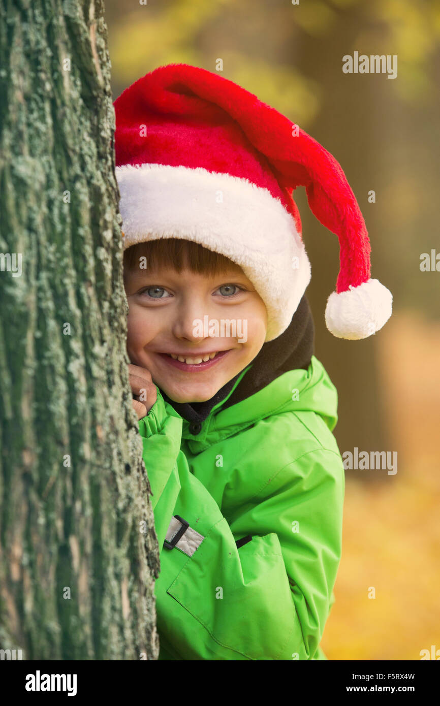 portrait of a boy with Santa hat in park in the fall Stock Photo - Alamy