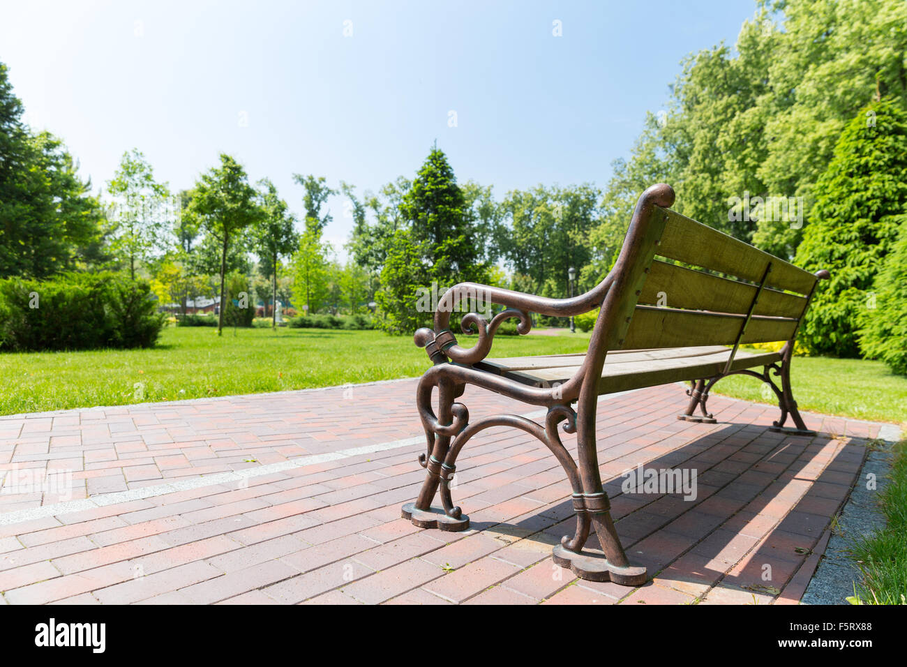 Bench in the park against the meadow Stock Photo - Alamy