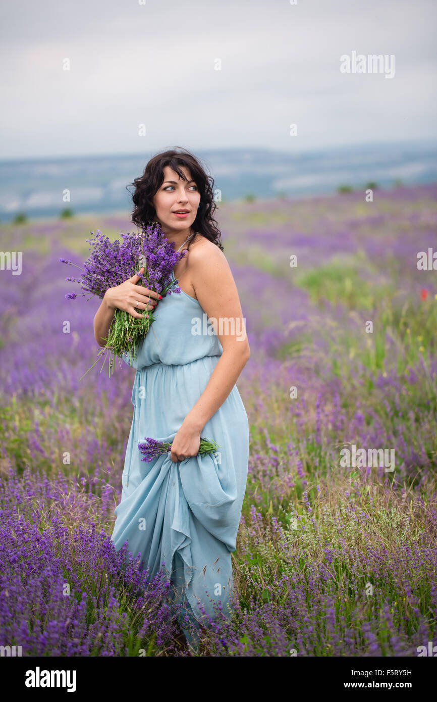 Young woman harvesting lavender flowers Stock Photo - Alamy