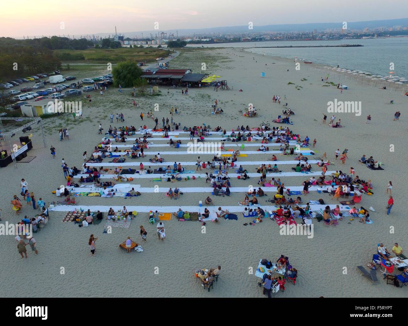 Thousands of people bring their dinner to an improvised table on ...