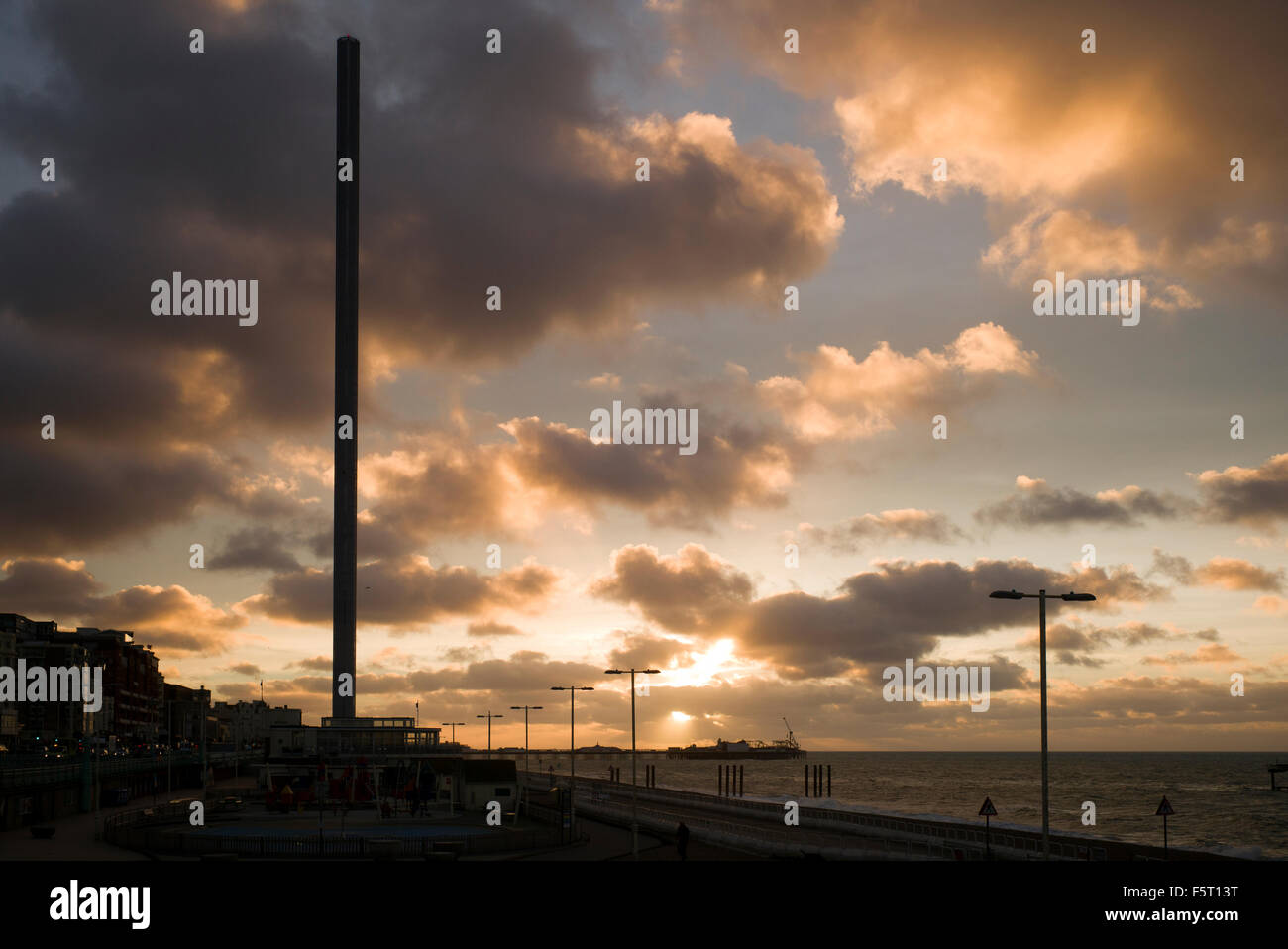 Brighton seashore at dawn showing i360 viewing tower, cloudy sky ...