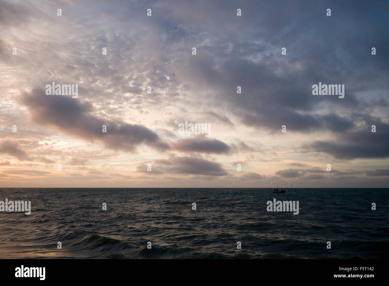 Distant fishing boat hi-res stock photography and images - Alamy