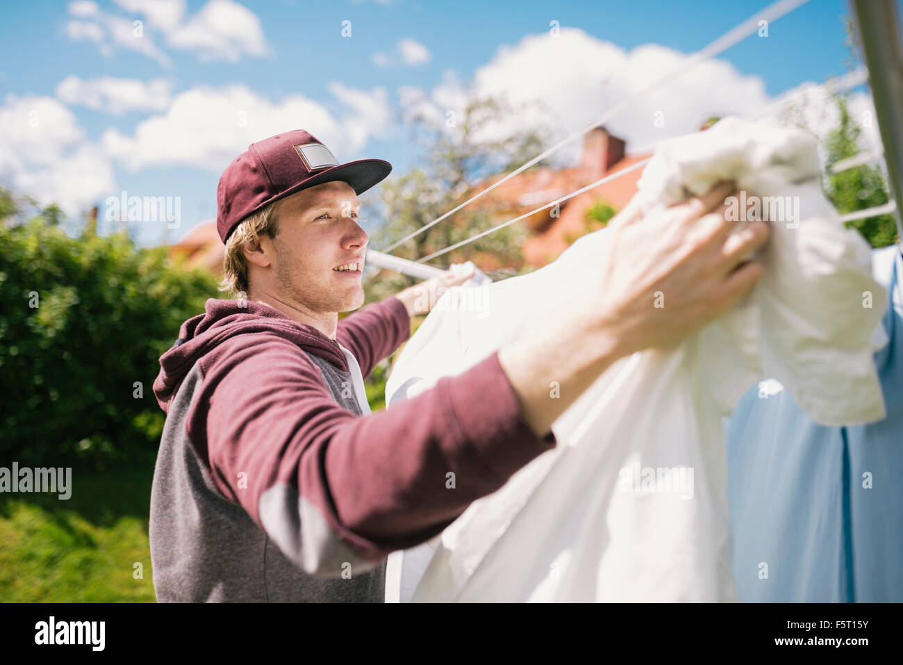 Man hanging up washing hi-res stock photography and images - Alamy