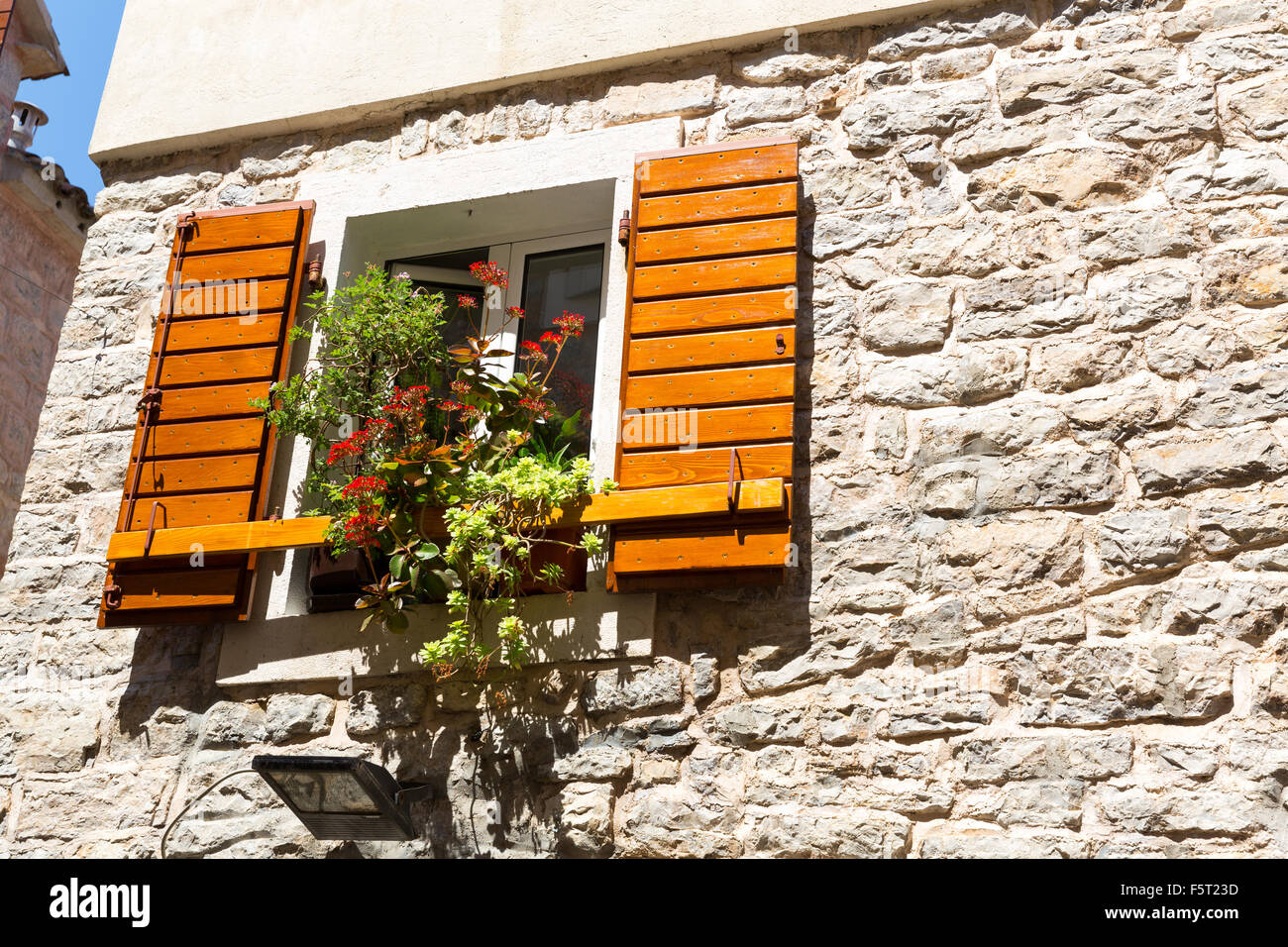 Nice balcony with flowers in apartment brick building Stock Photo - Alamy
