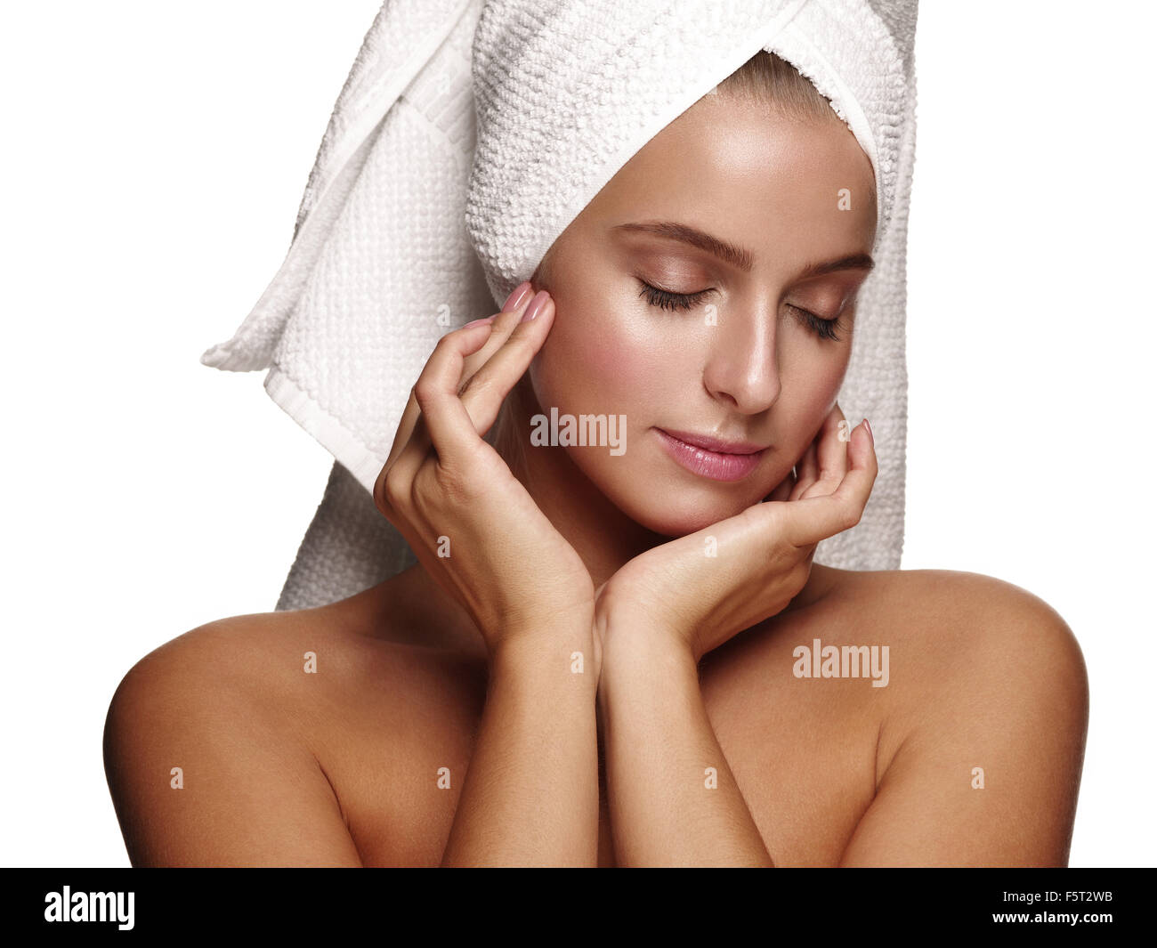 Girl after a shower with a towel on her head. She does daily skincare ...