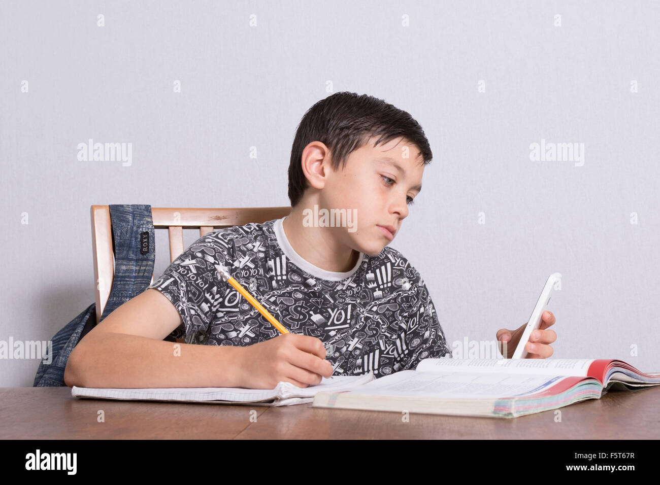 Pre-teen boy doing his homework Stock Photo - Alamy