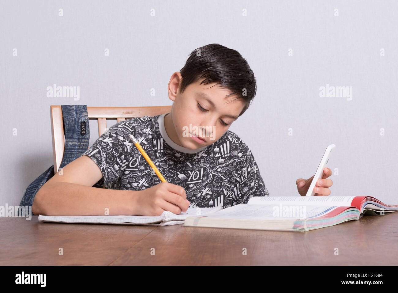 Pre-teen boy doing his homework Stock Photo - Alamy