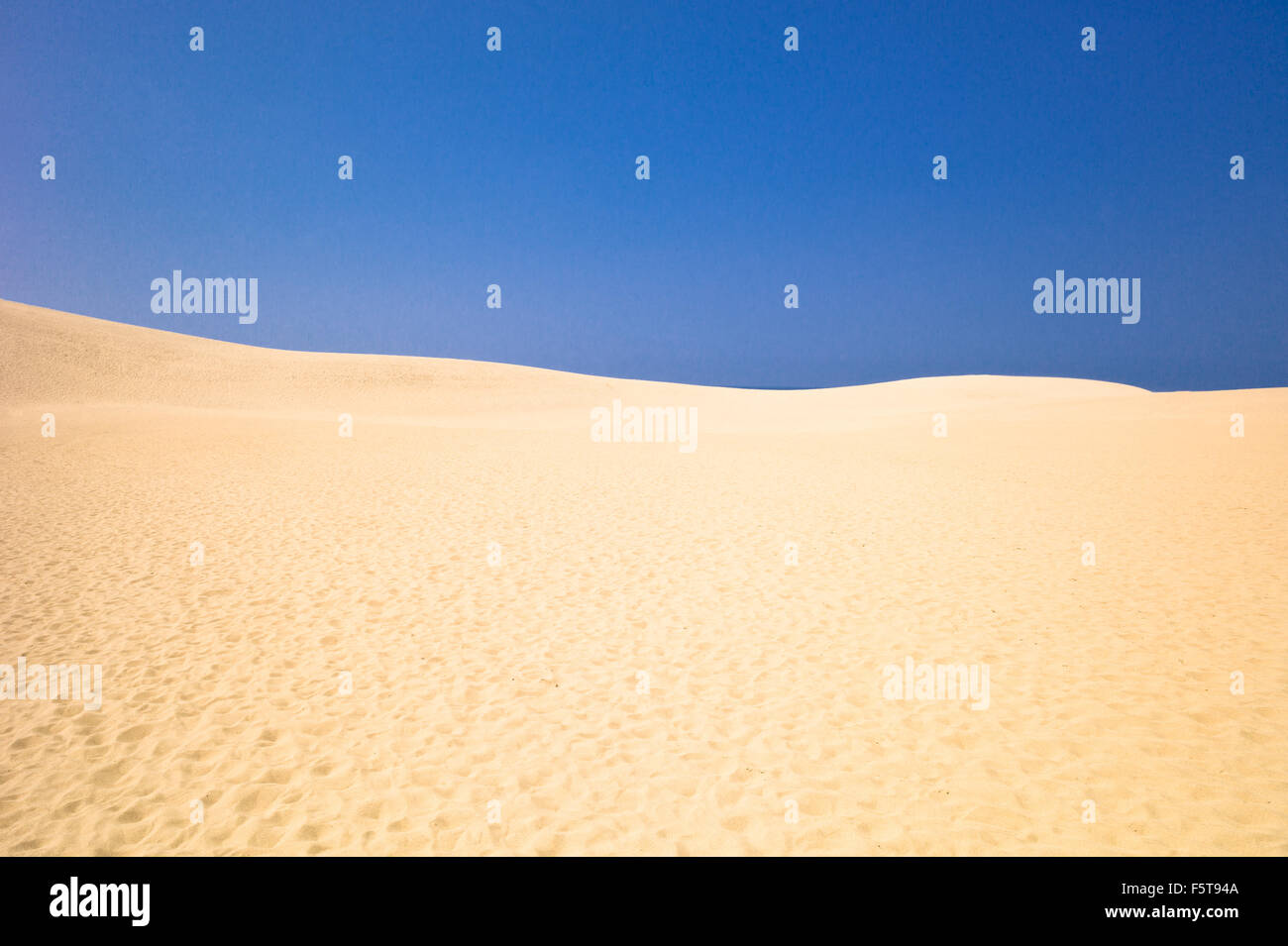 Brightness: Sand and blue sky background Stock Photo - Alamy