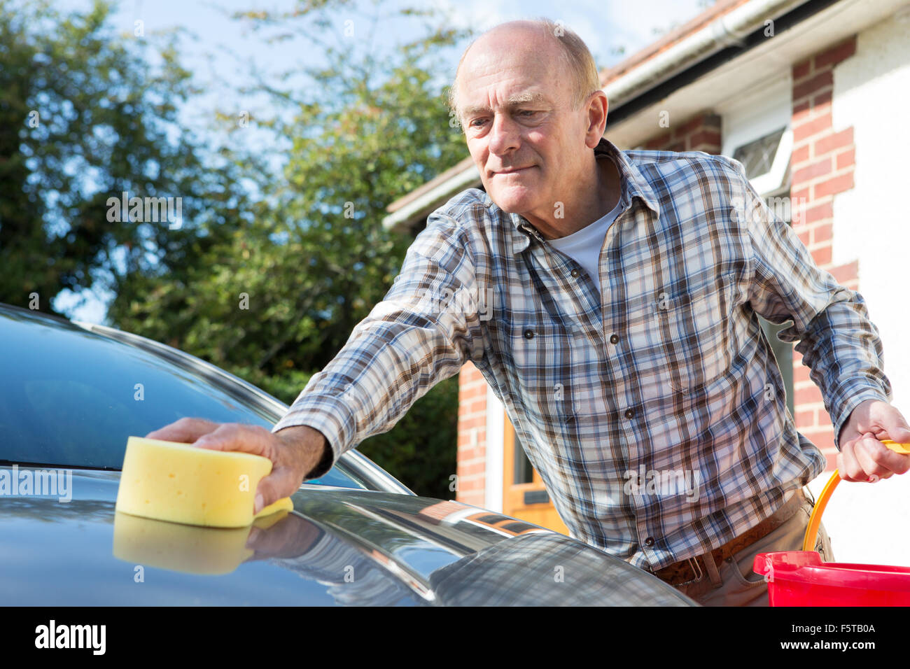 Senior Man Washing Car With Sponge Stock Photo - Alamy