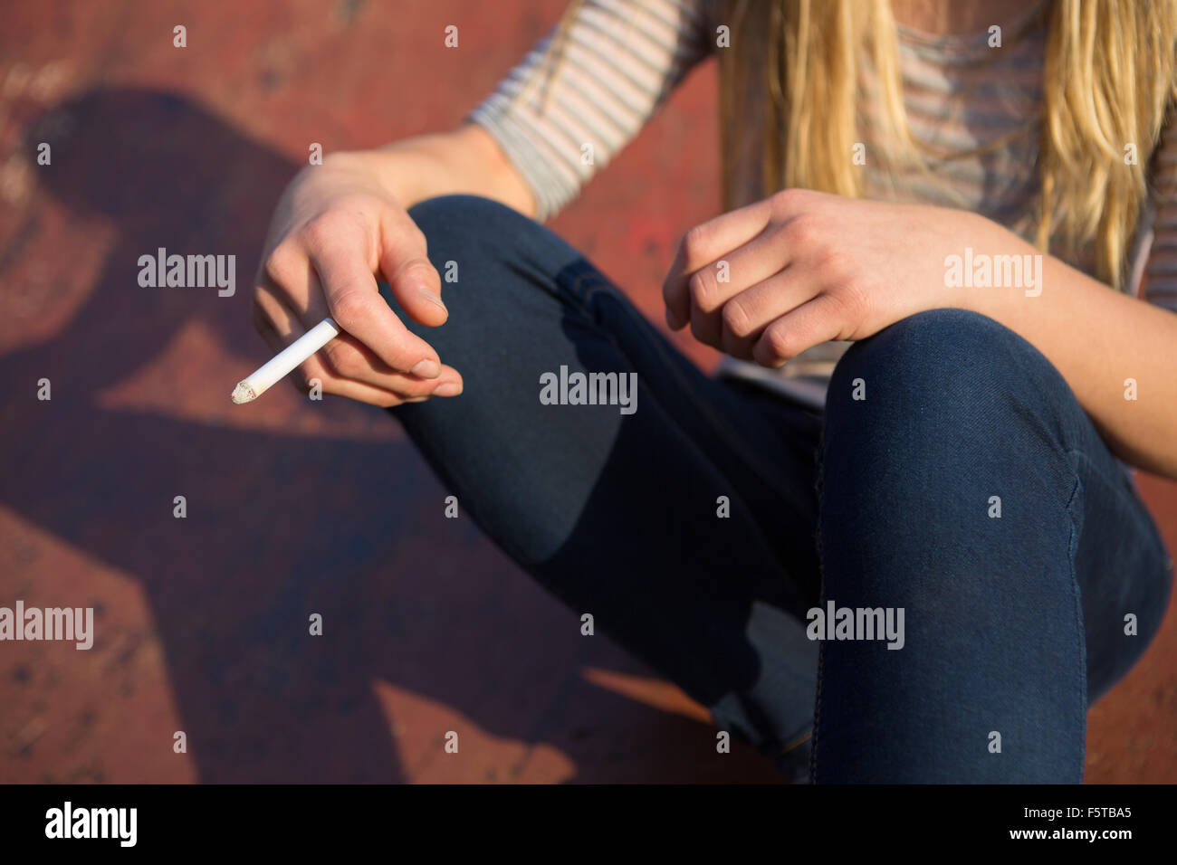 Close Up Of Teenage Girl Smoking Cigarette Outdoors Stock Photo - Alamy