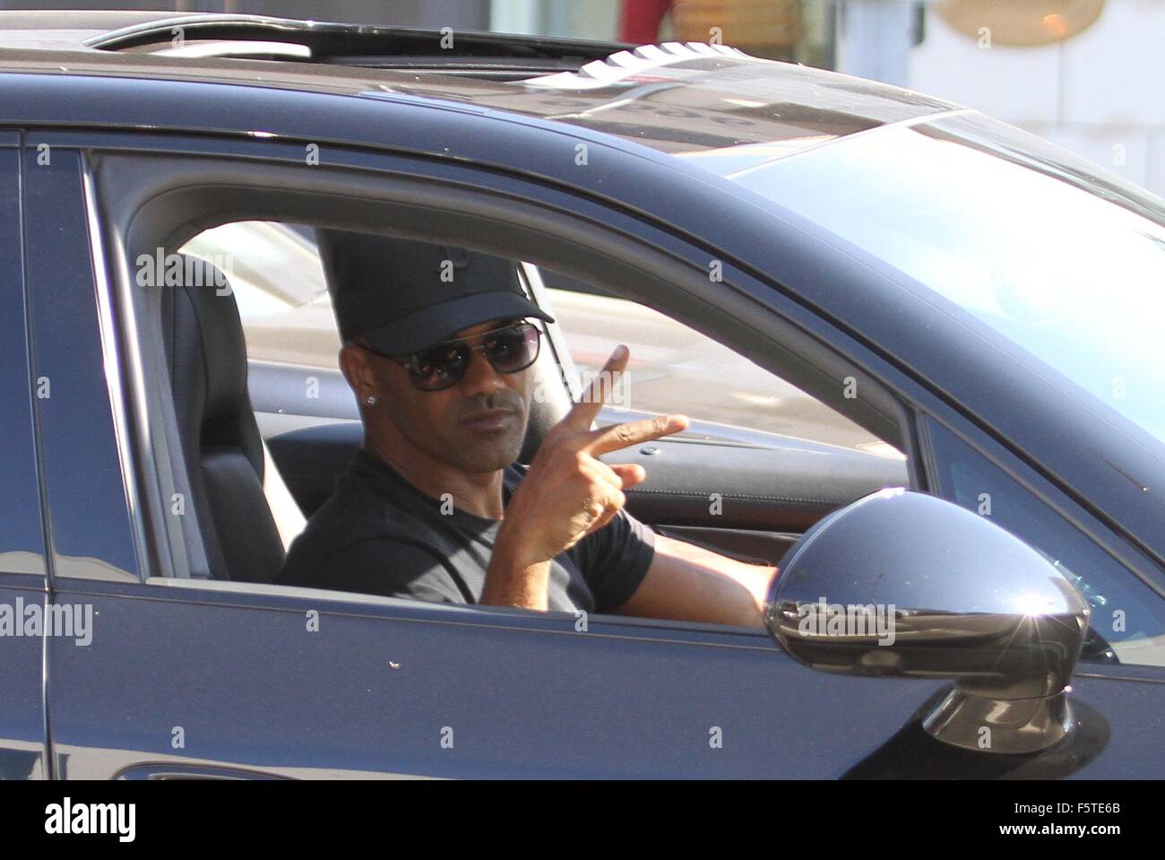 Criminal Minds star, Shemar Moore makes a hand gesture while driving ...
