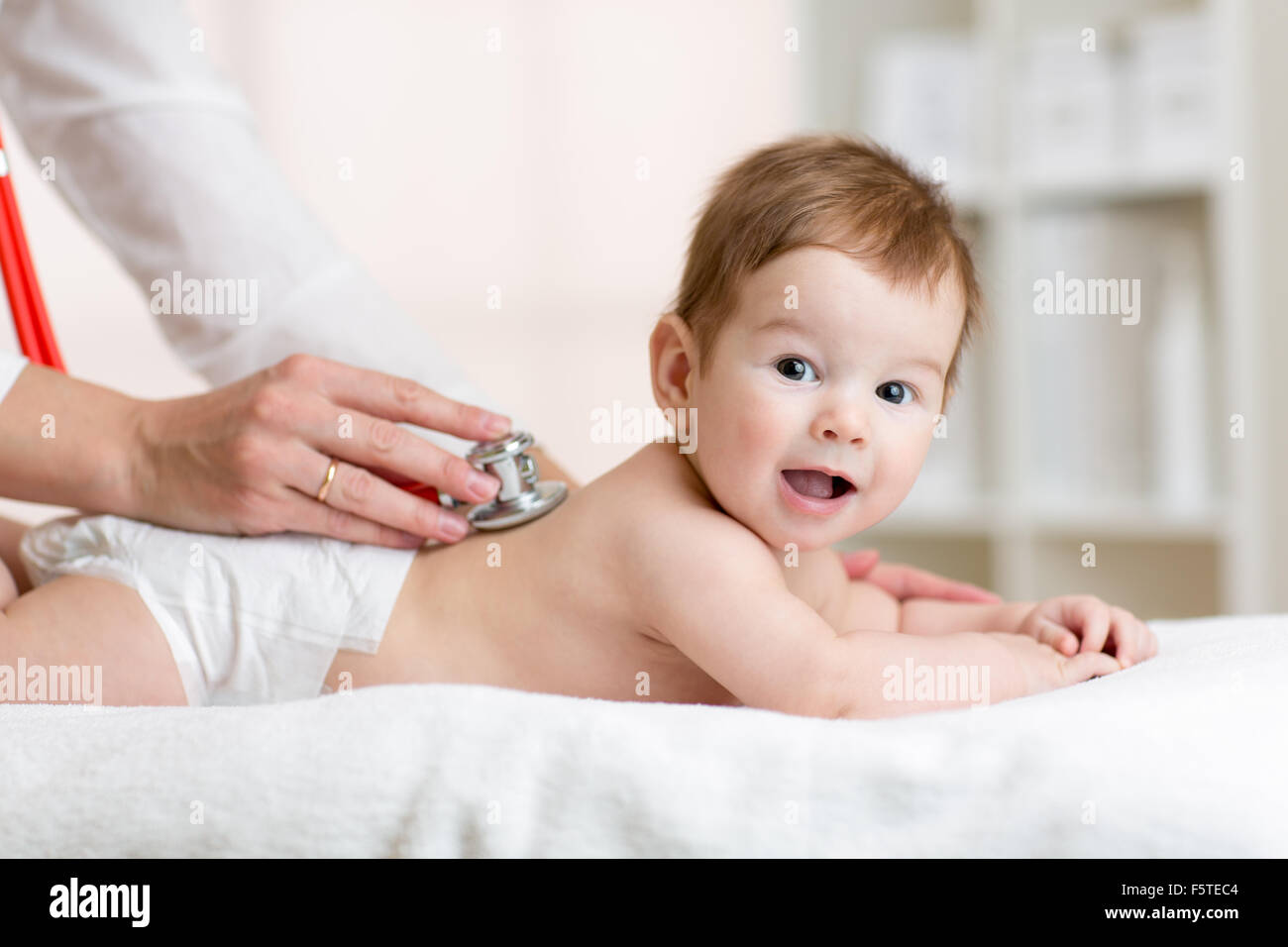 doctor examining baby boy with stethoscope Stock Photo - Alamy