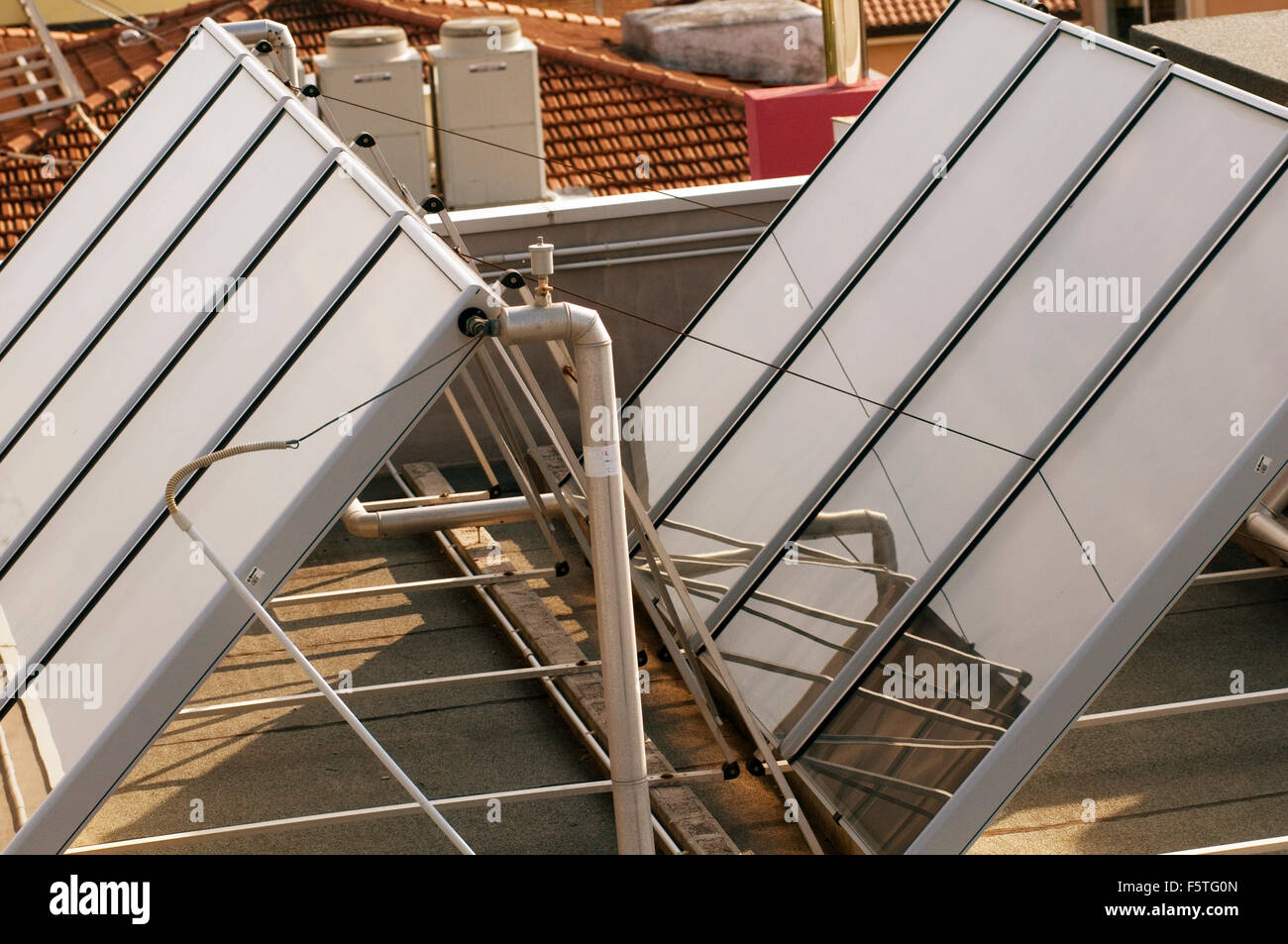 solar water heating panel panels warm hot heat rooftop roof Stock Photo ...