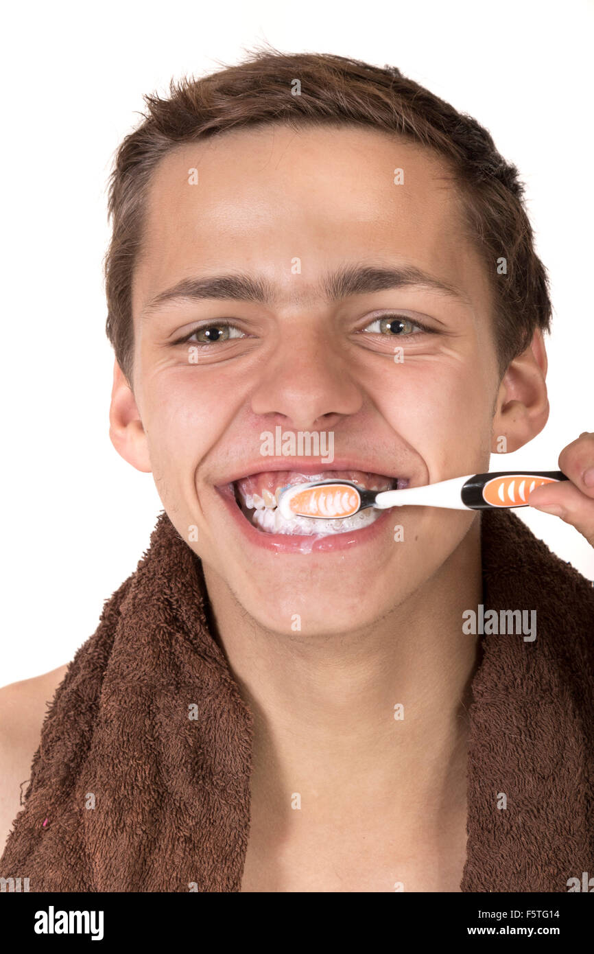 Teenage boy cleaning his teeth Stock Photo - Alamy