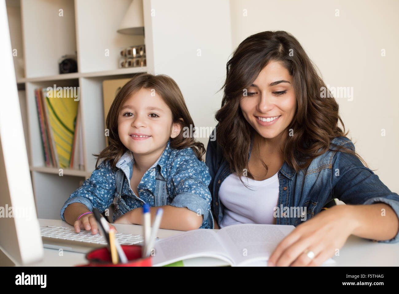 Mother helping her little child with homework Stock Photo - Alamy