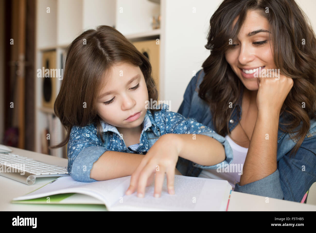 Mother helping her little child with homework Stock Photo - Alamy