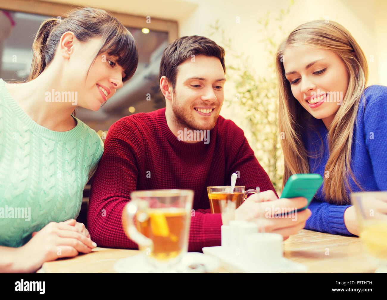 group of friends with smartphone meeting at cafe Stock Photo - Alamy