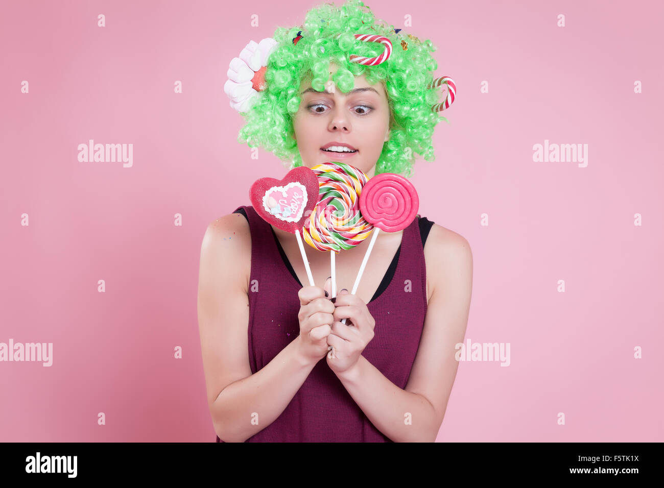 Young woman posing happy with some candies Stock Photo - Alamy