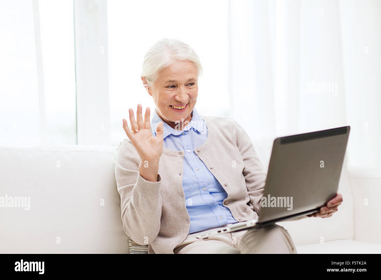 senior woman with laptop having video chat at home Stock Photo - Alamy