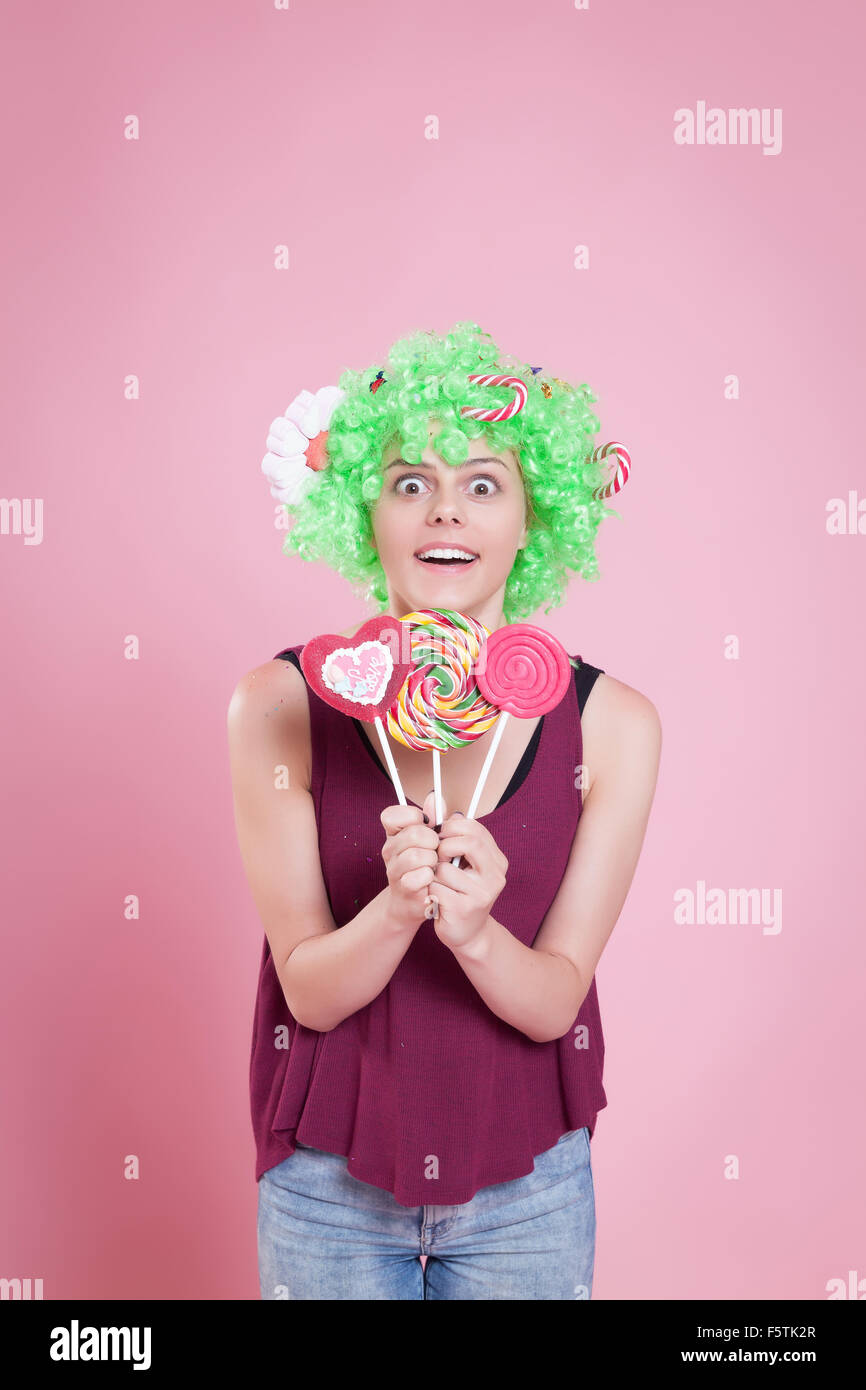 Young woman posing happy with some candies Stock Photo - Alamy