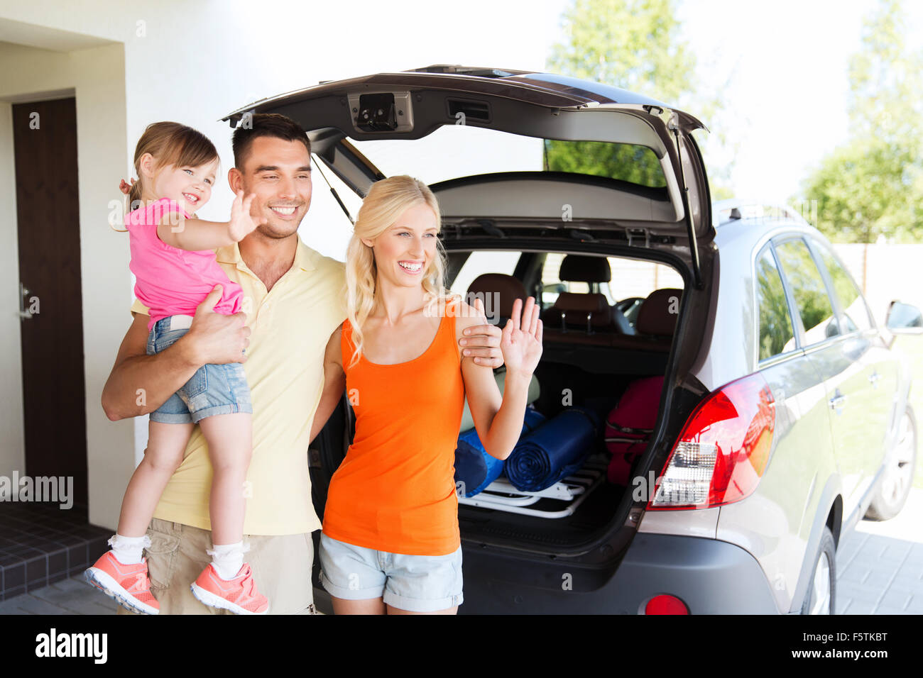 happy family with hatchback car at home parking Stock Photo - Alamy