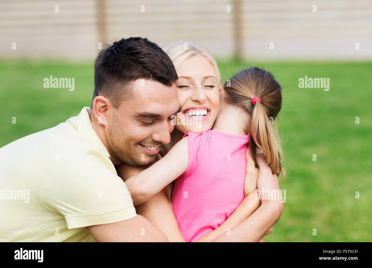 happy family hugging outdoors Stock Photo - Alamy