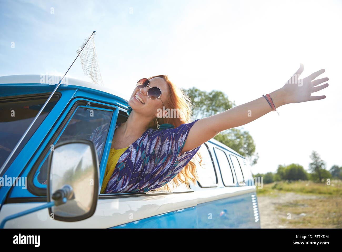 smiling young hippie woman driving minivan car Stock Photo - Alamy