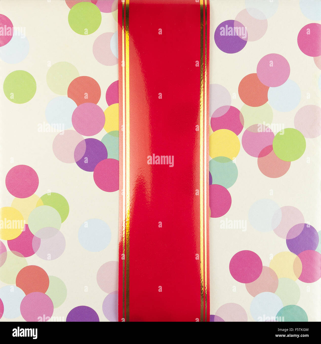 Big red ribbon on color gift paper Stock Photo - Alamy