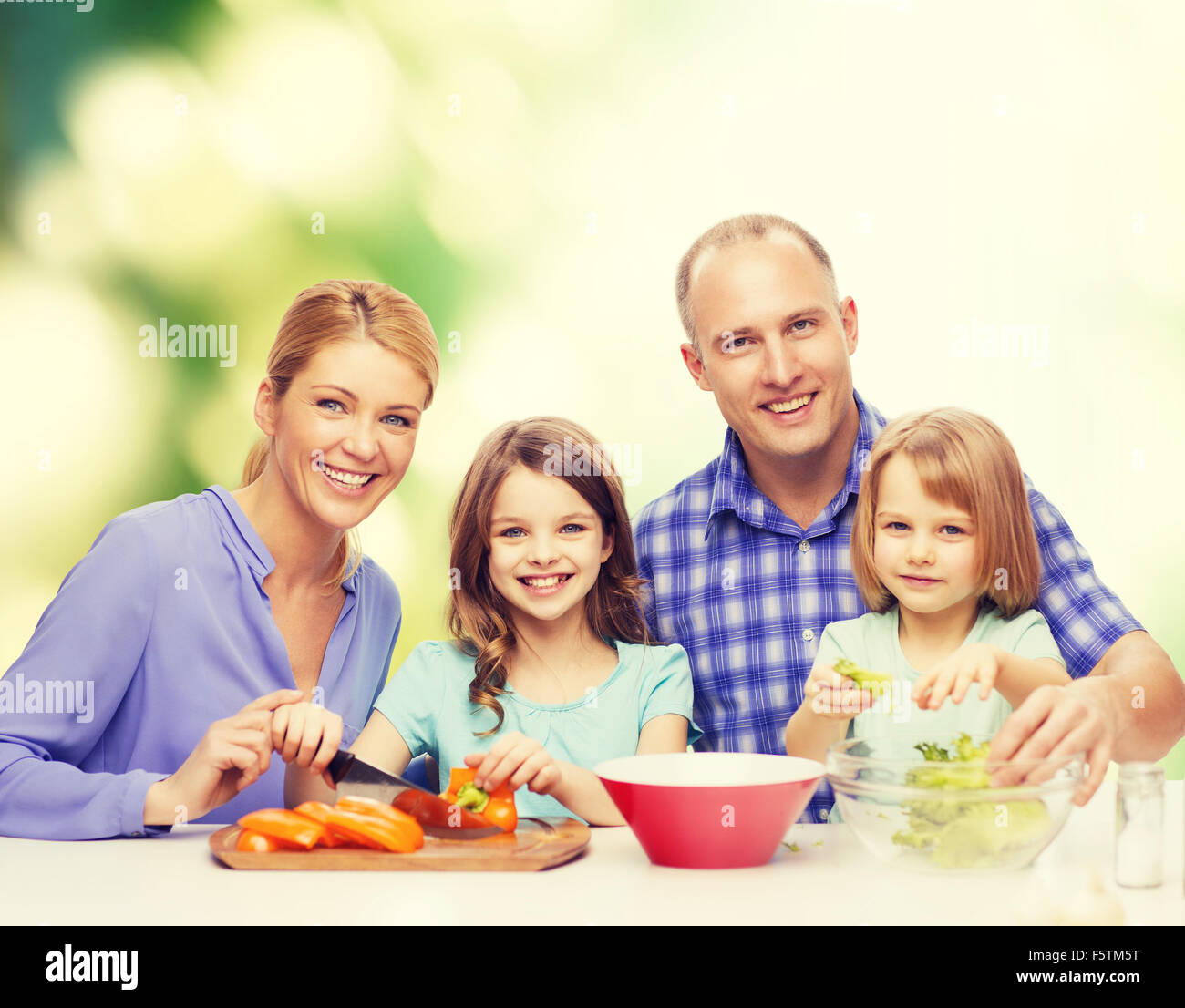 happy family with two kids making dinner at home Stock Photo - Alamy