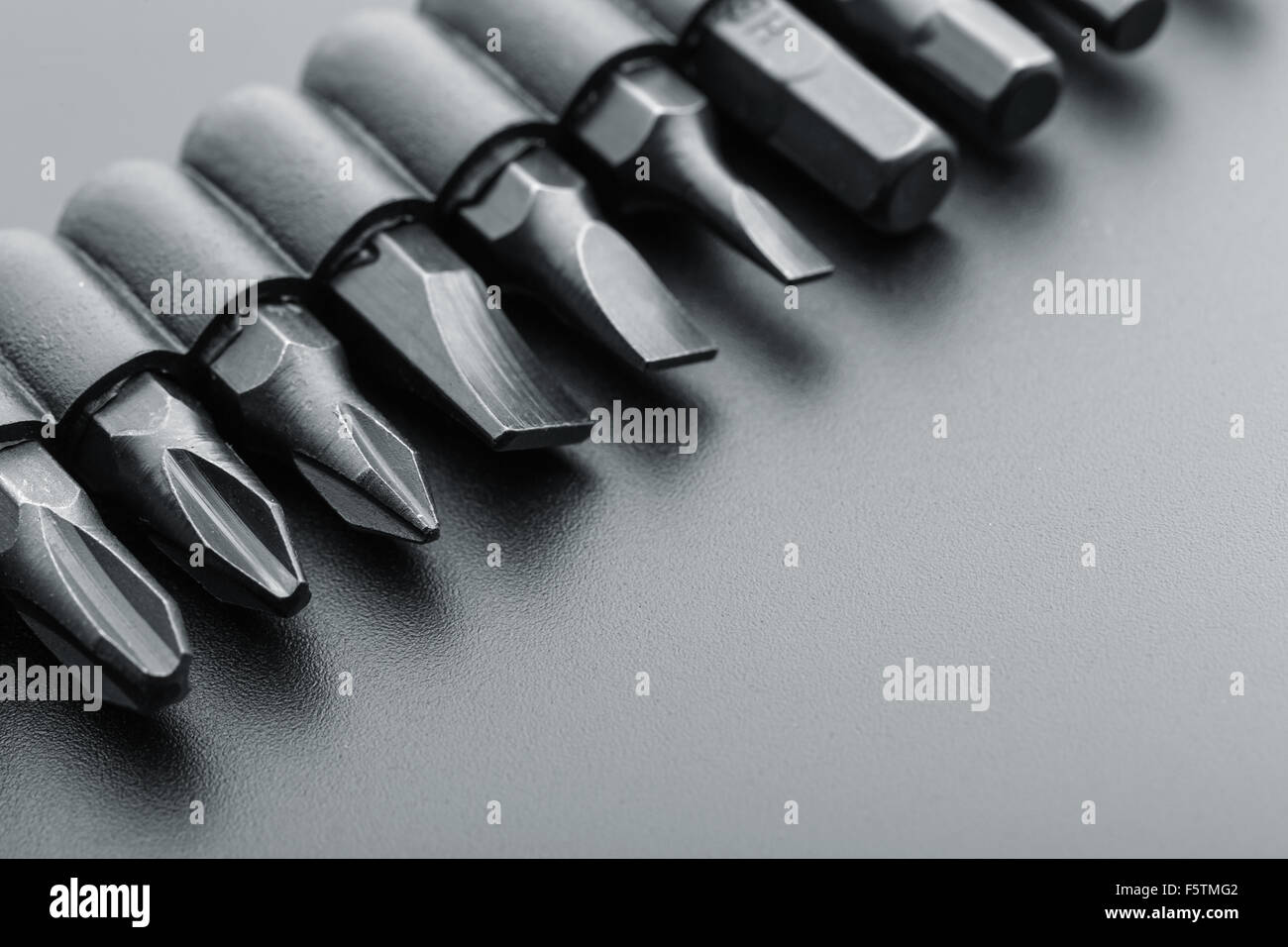 Macro view of screwdriver bits on grey Stock Photo - Alamy