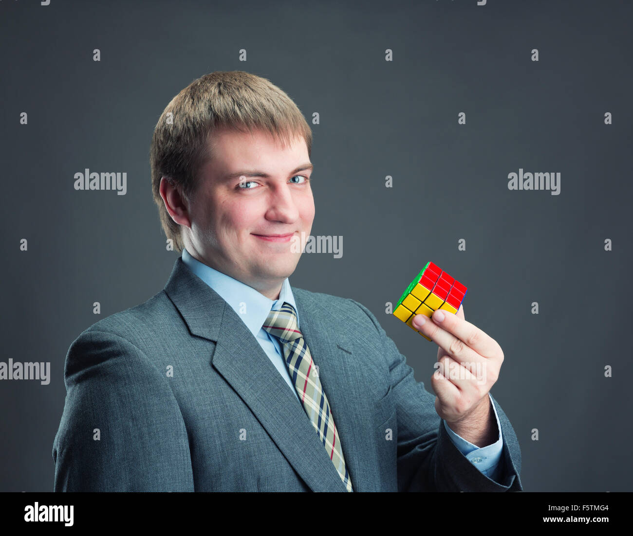 Happy businessman holding rubik cube hi-res stock photography and ...