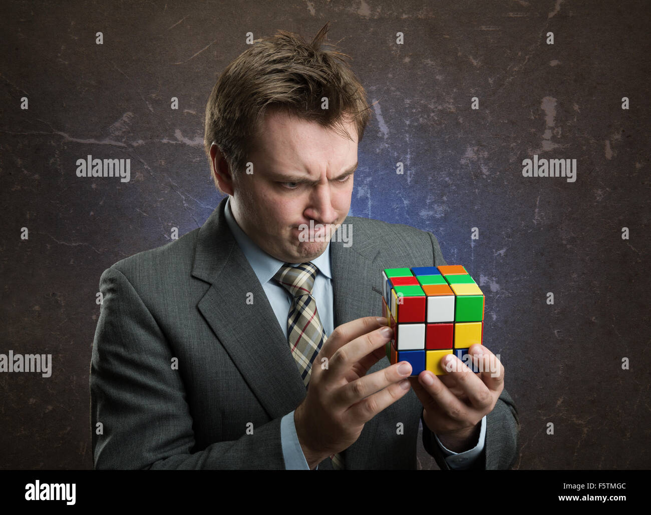 Businessman holding colorful cube in his hands Stock Photo - Alamy
