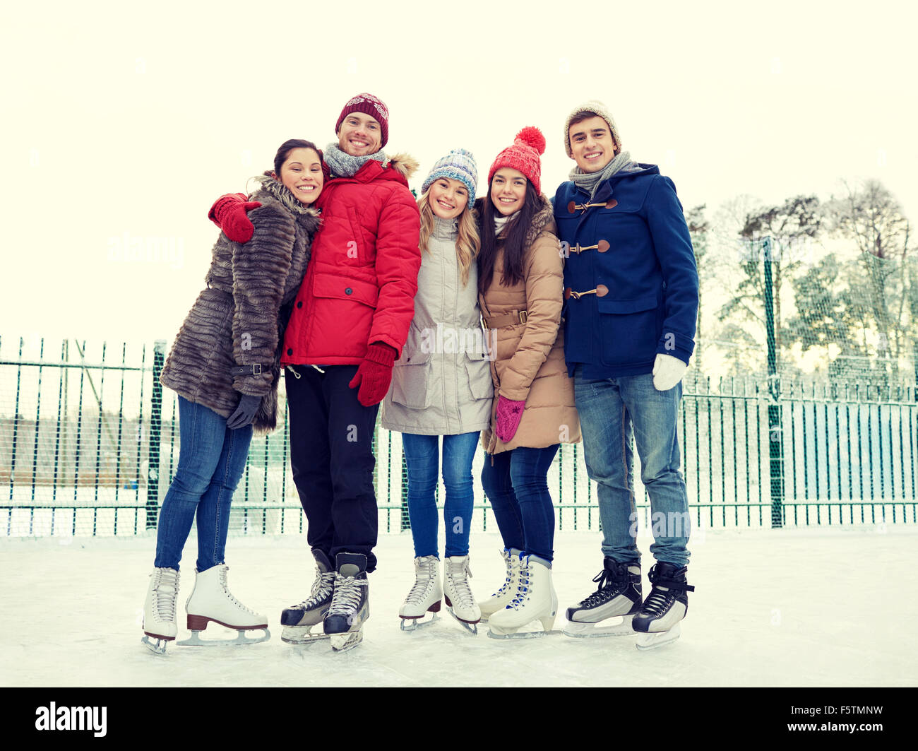 happy friends ice skating on rink outdoors Stock Photo - Alamy