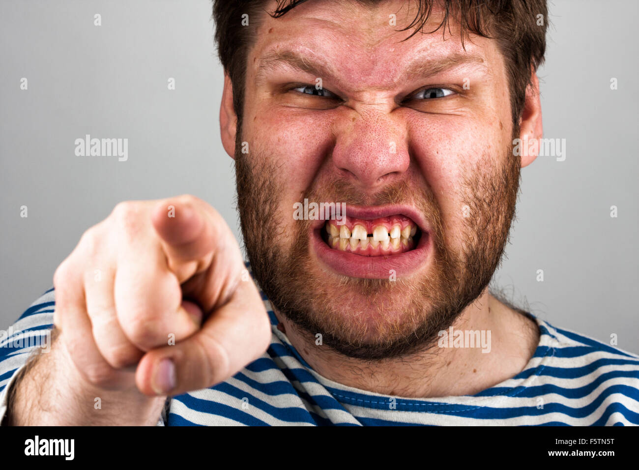 Portrait of angry bearded man pointing to you Stock Photo - Alamy